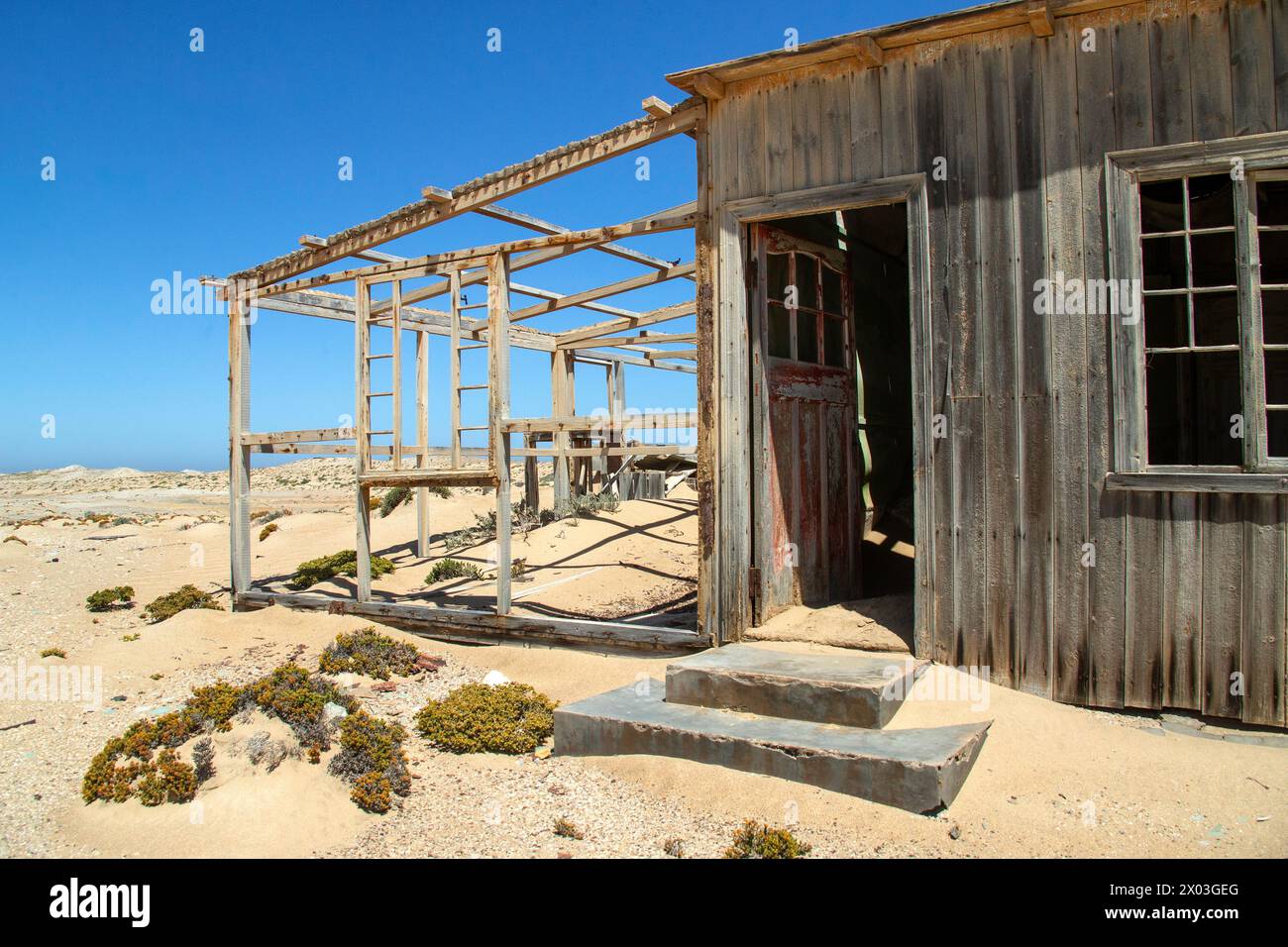 The lean to and once red door of an abandoned miner's house, preserved ...