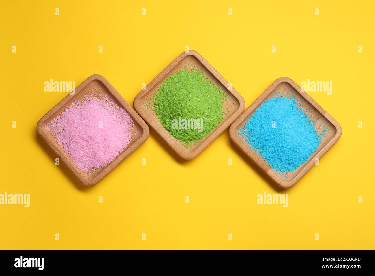 Different sea salt on yellow background, flat lay Stock Photo - Alamy