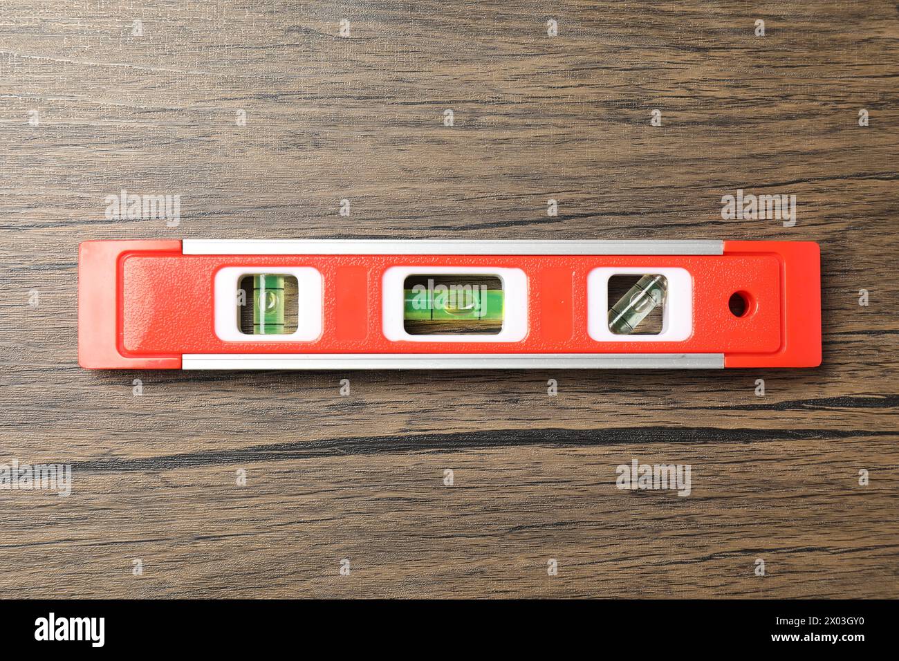 Building level on wooden table, top view Stock Photo - Alamy