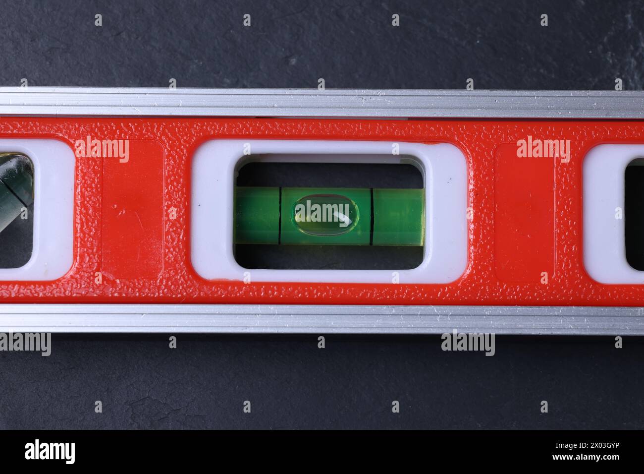 Building level on black table, top view Stock Photo - Alamy
