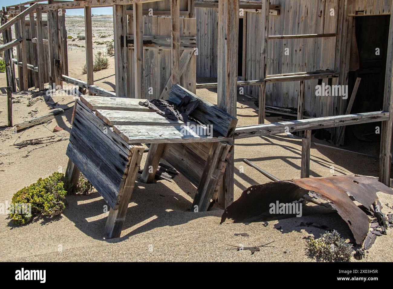 A work bench outside the timber frame of an abandoned, miner's house ...