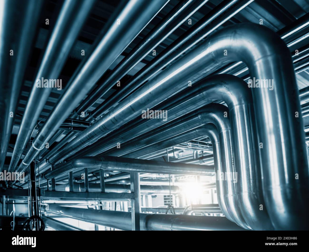 Network of gleaming steel pipes runs with precision, illustrating vital ...