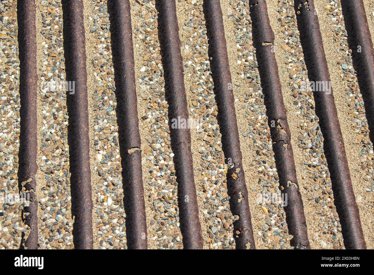 Corrugated iron roofing panel, half buried in the sand in the abandoned ...