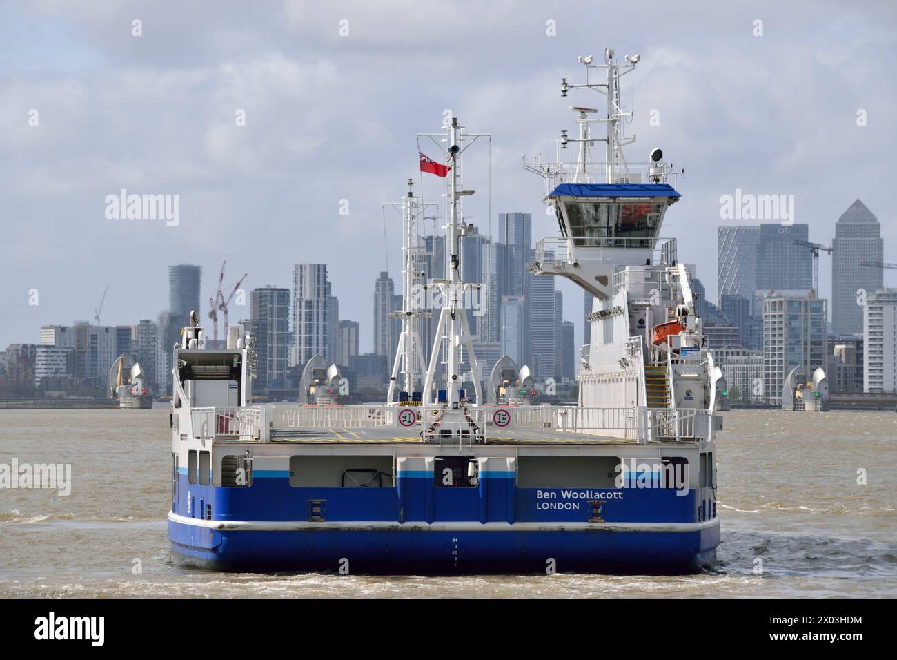 Woolwich Ferry BEN WOOLLACOTT crew training on the River Thames with the Canary Wharf skyline ...