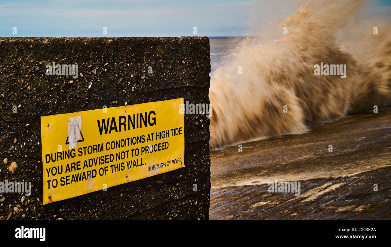Storm conditions warning sign on seawall at Cleveleys,UK Stock Photo ...