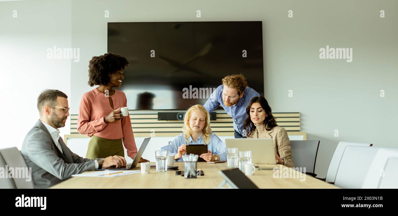 Multiethnic group of professionals brainstorming around a conference ...