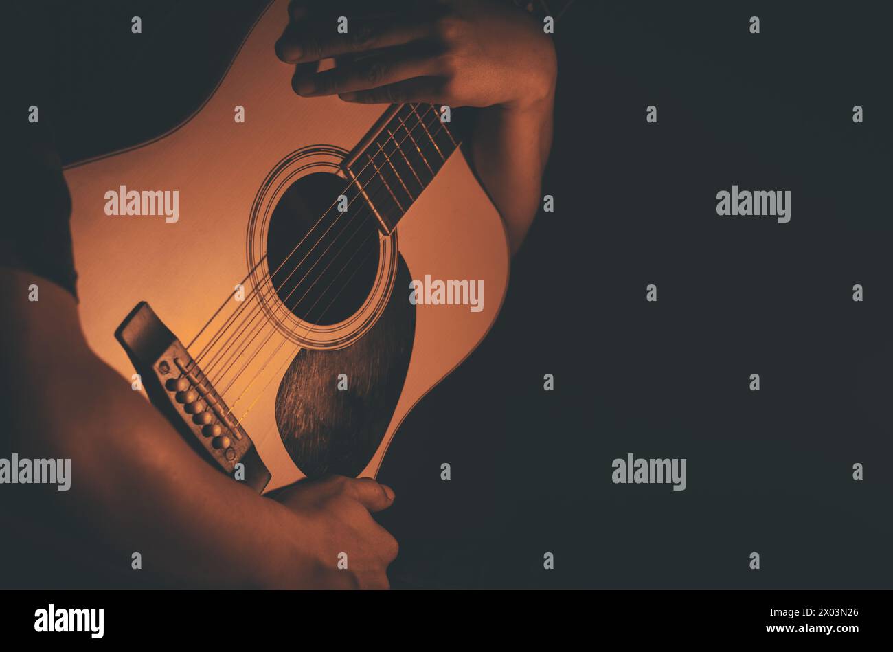Man hugging acoustic guitar. Music background Stock Photo - Alamy