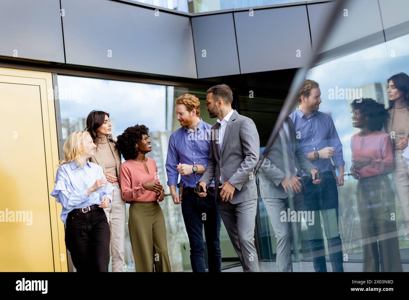 Group of colleagues in a casual business huddle, sharing ideas next to ...