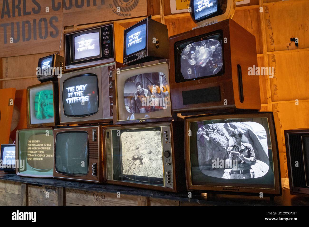 Nostalgic display of classic televisions with old movies playing. 2023 ...