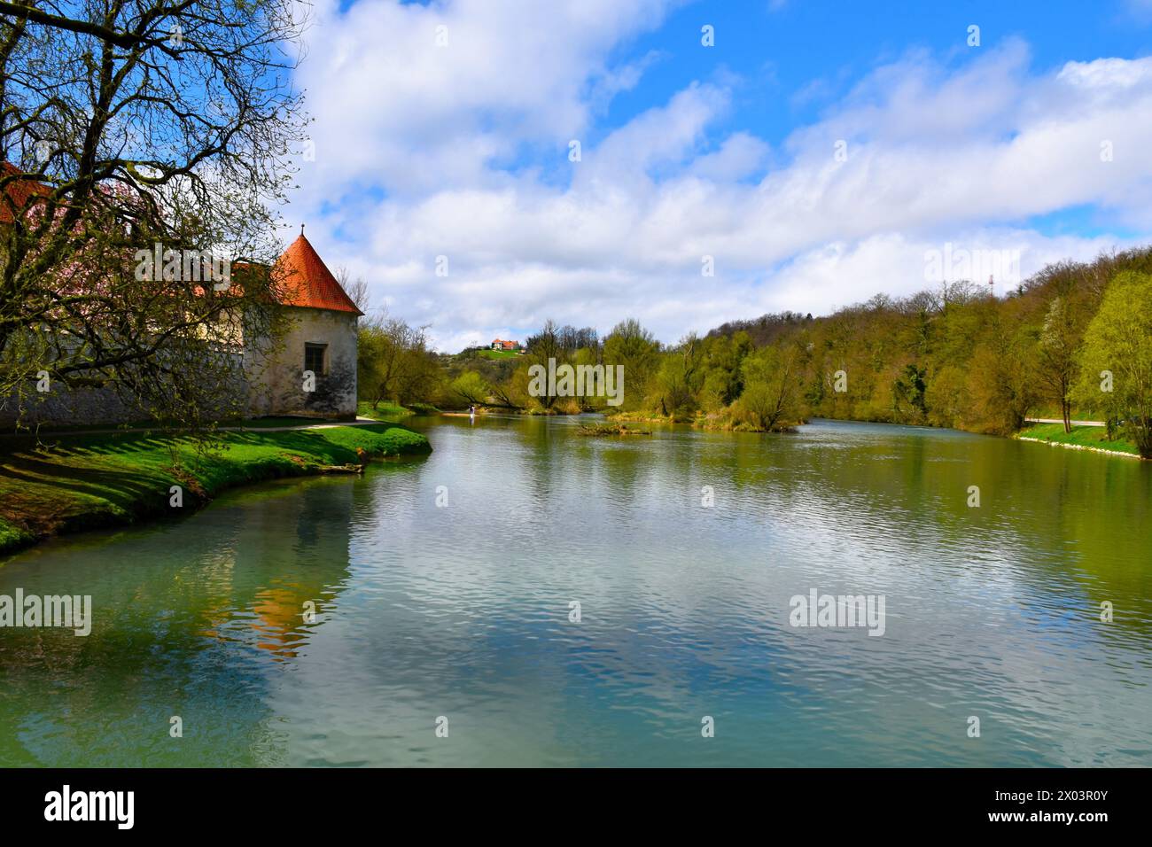 View of Krka river and defensife tower of Otečec castle on the shore in Dolenjska, Slovenia ...