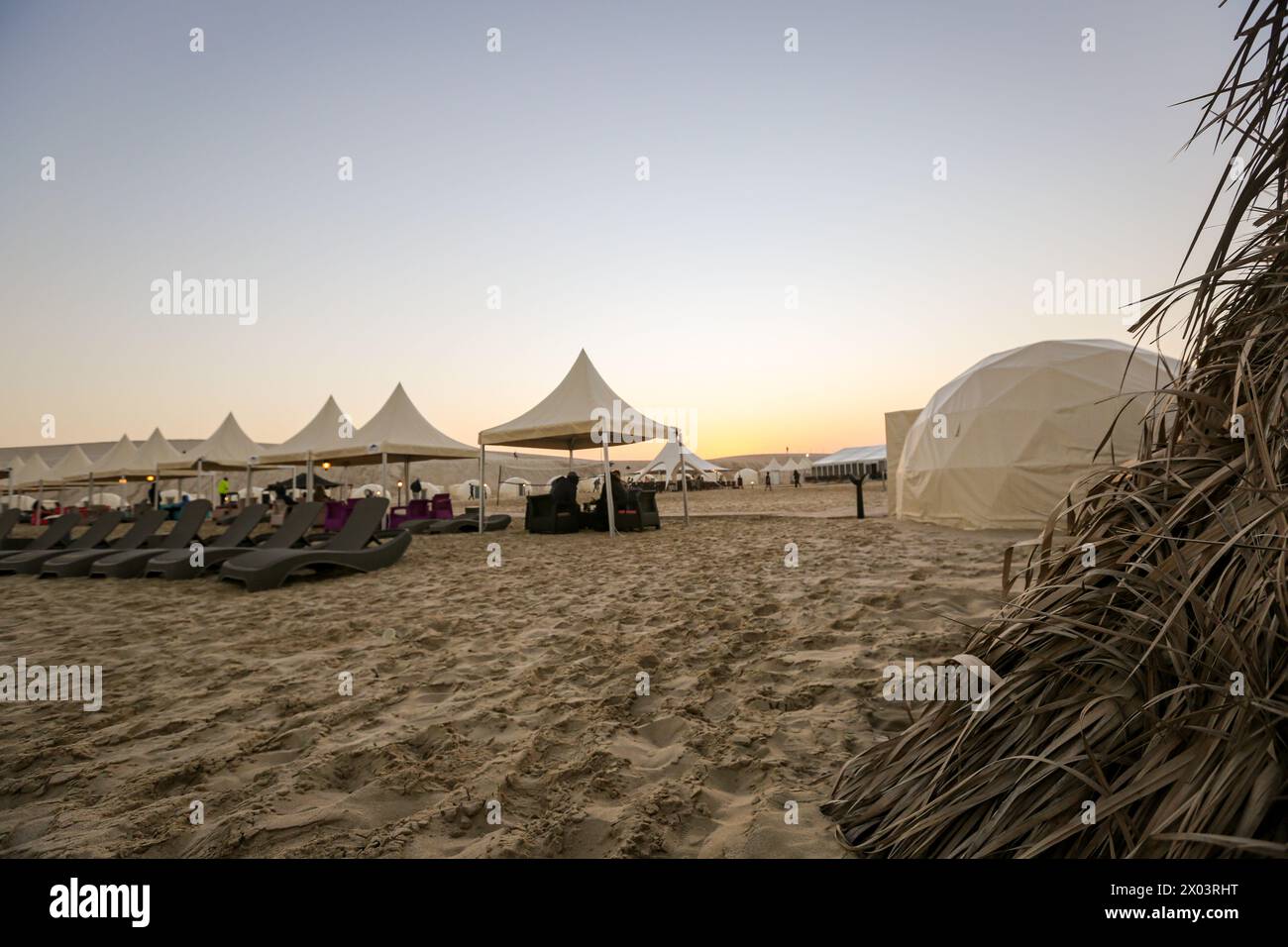 QIA desert camp at Inland Sea in Persian Gulf at sunset sky. Middle ...