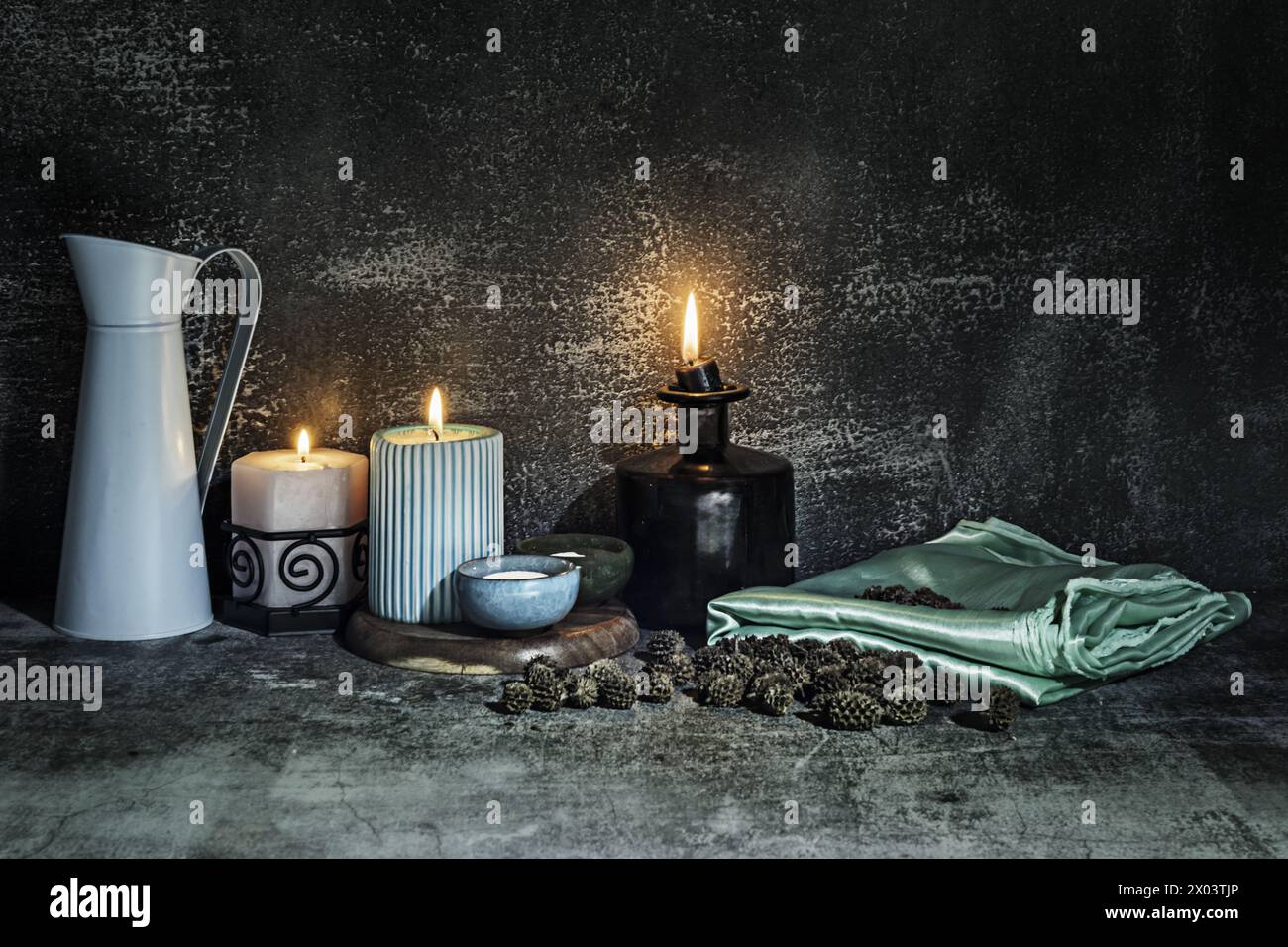 A still life with a green satin cloth next to several lit candles Stock ...
