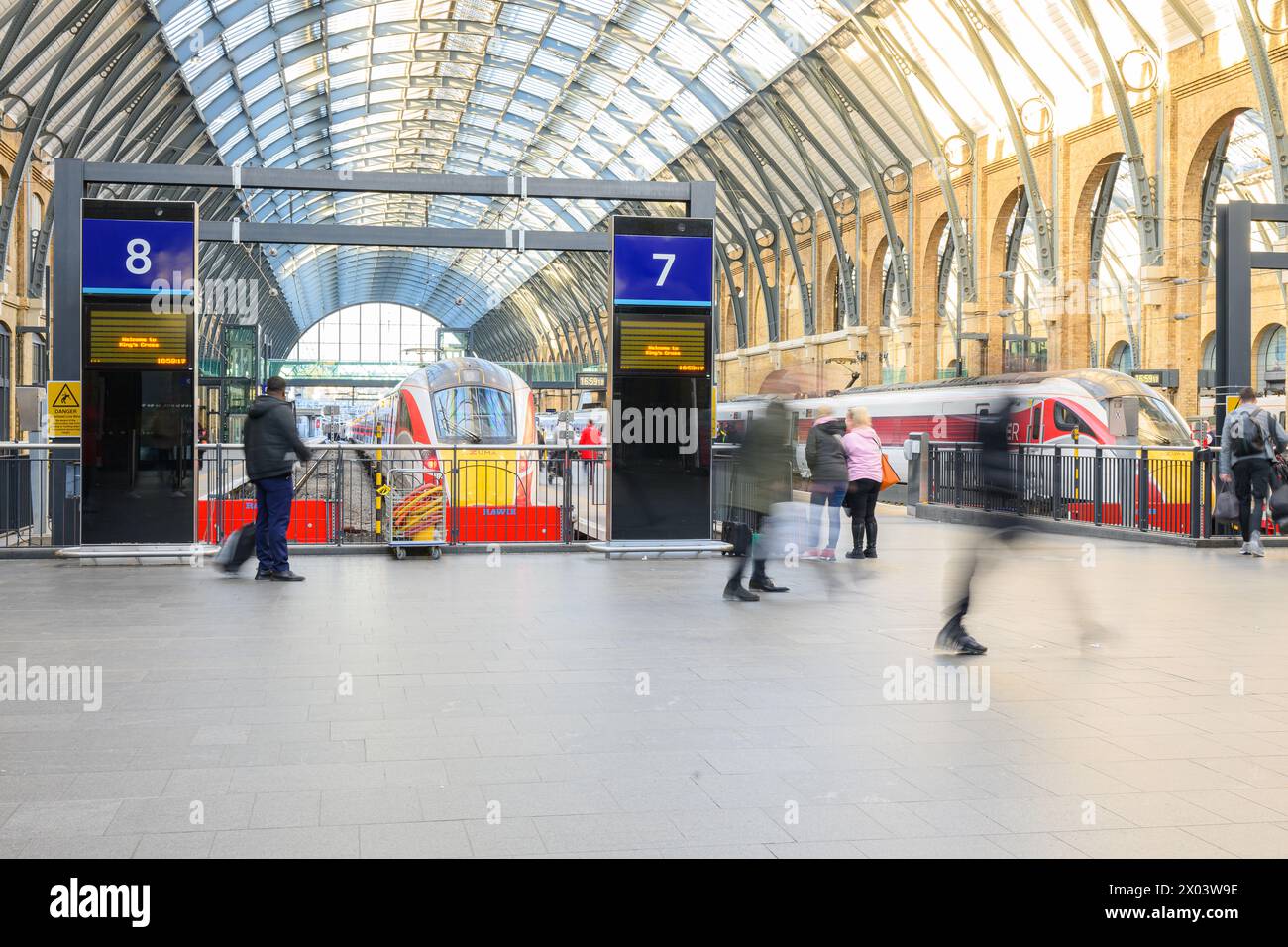 London, UK - March 24, 2024; Slow motion shadows of passengers walking ...