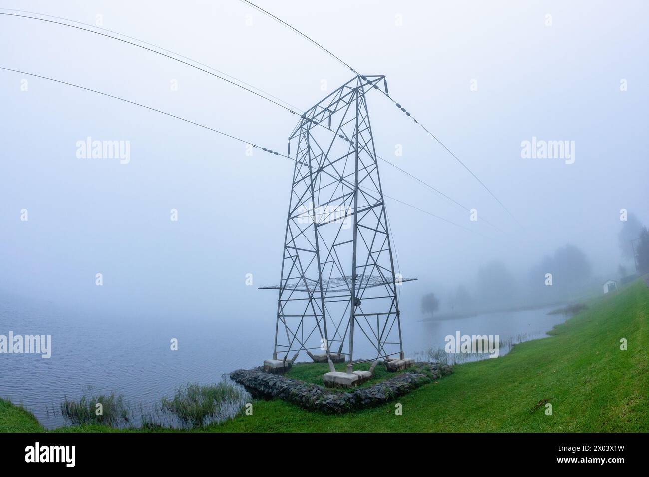 Electrical Power-lines Tower with high voltage cable on waters-edge ...