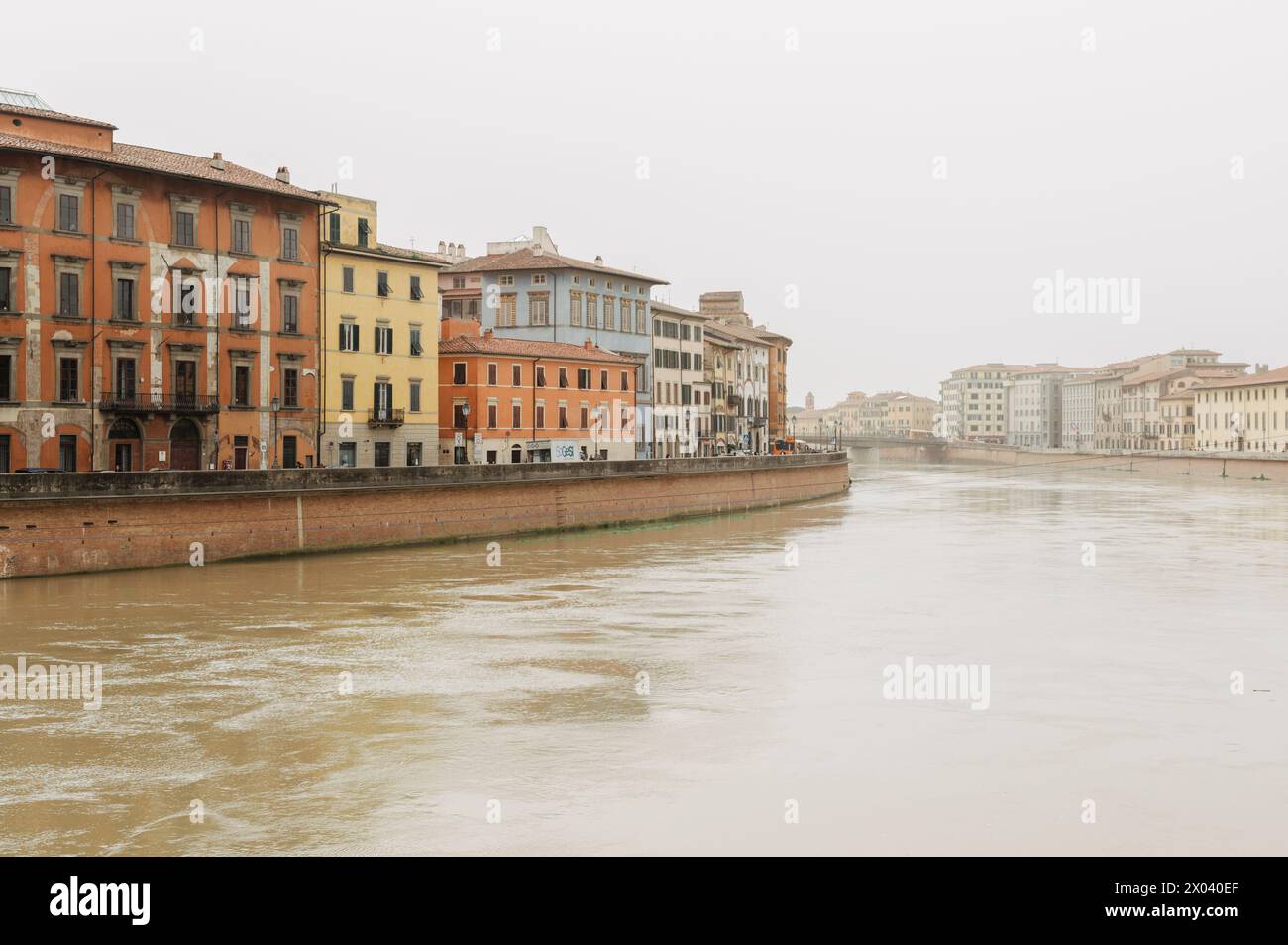 Overview of the Arno river flowing in the city of Pisa between old ...