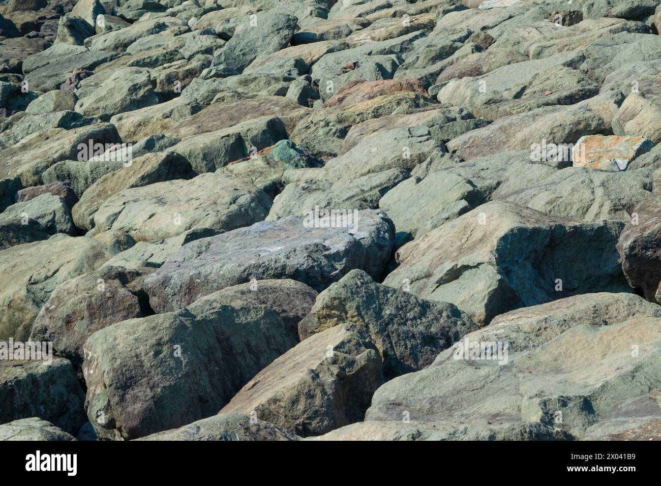 Lots of big stones. Stone background. Strengthening the coastline ...