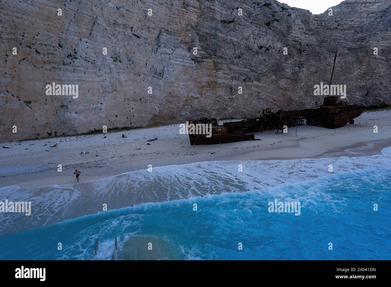 A beautiful view of a deserted beach with a sunken pirate ship washed ...