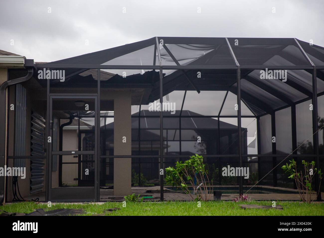 Family home Lanai damaged screened pool Stock Photo - Alamy