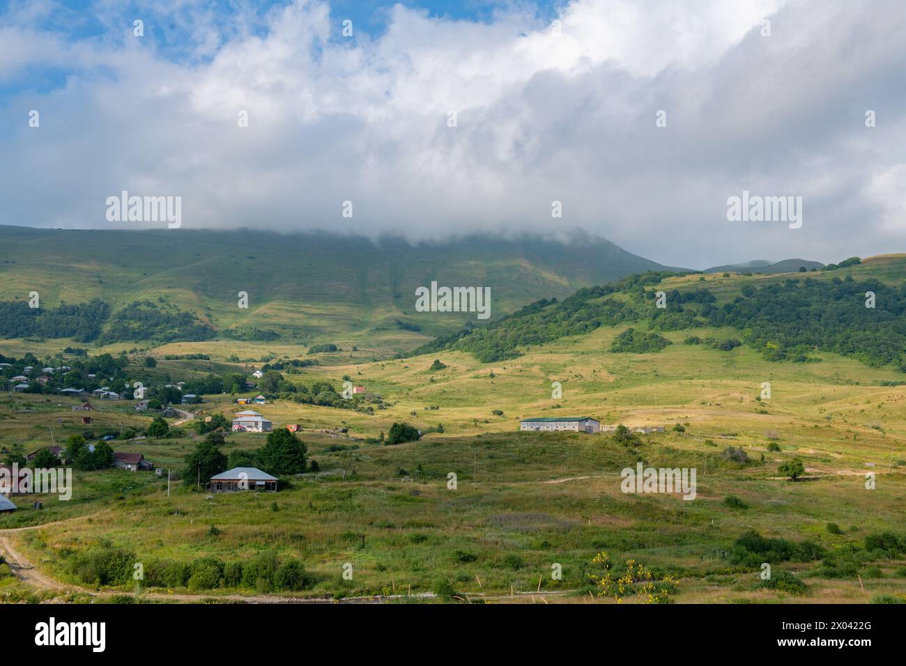 Verdant Canopy: Blue Sky Blanketed Over Green Mountain Ranges Stock ...