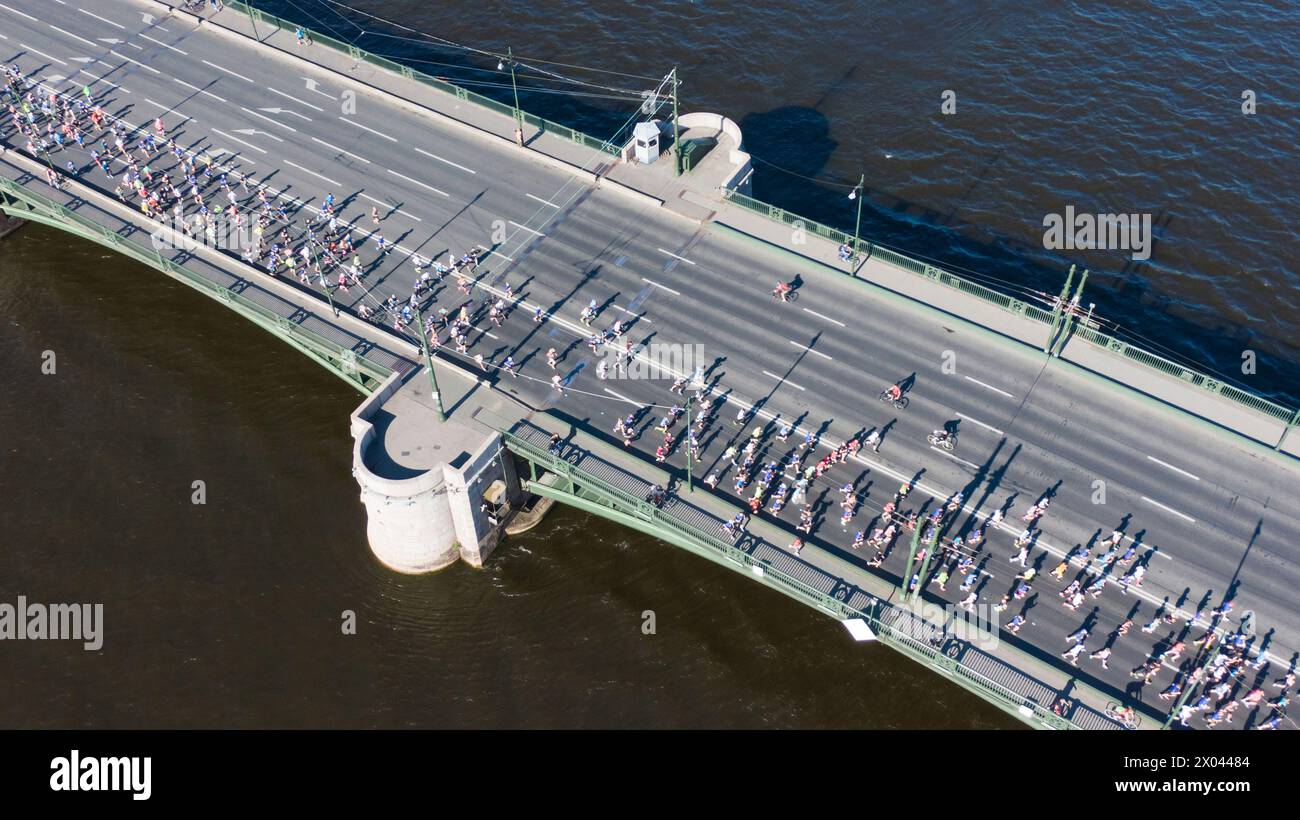 Aerial View of Marathon Runners on a Bridge Crossing a River. A city ...