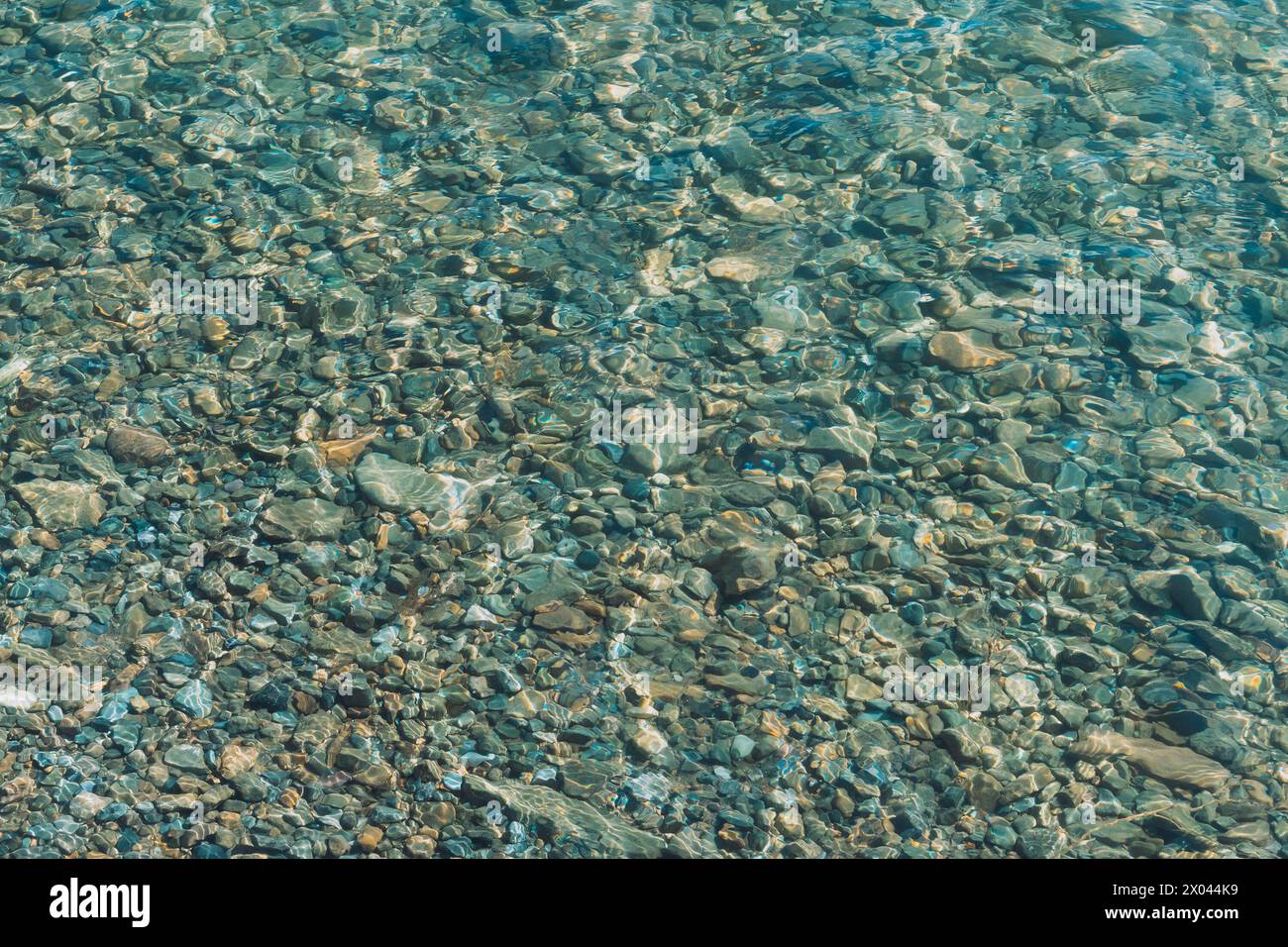 Transparent, clean water in the lake. Pebbles at the bottom of the lake ...