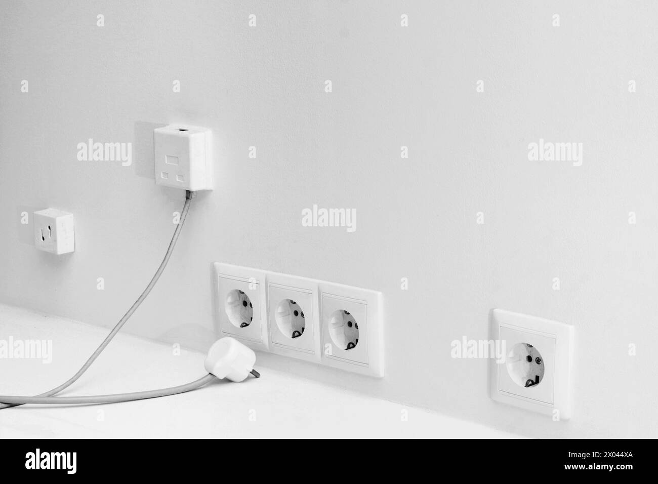 A power cord cable is disconnected from a group of white European ...