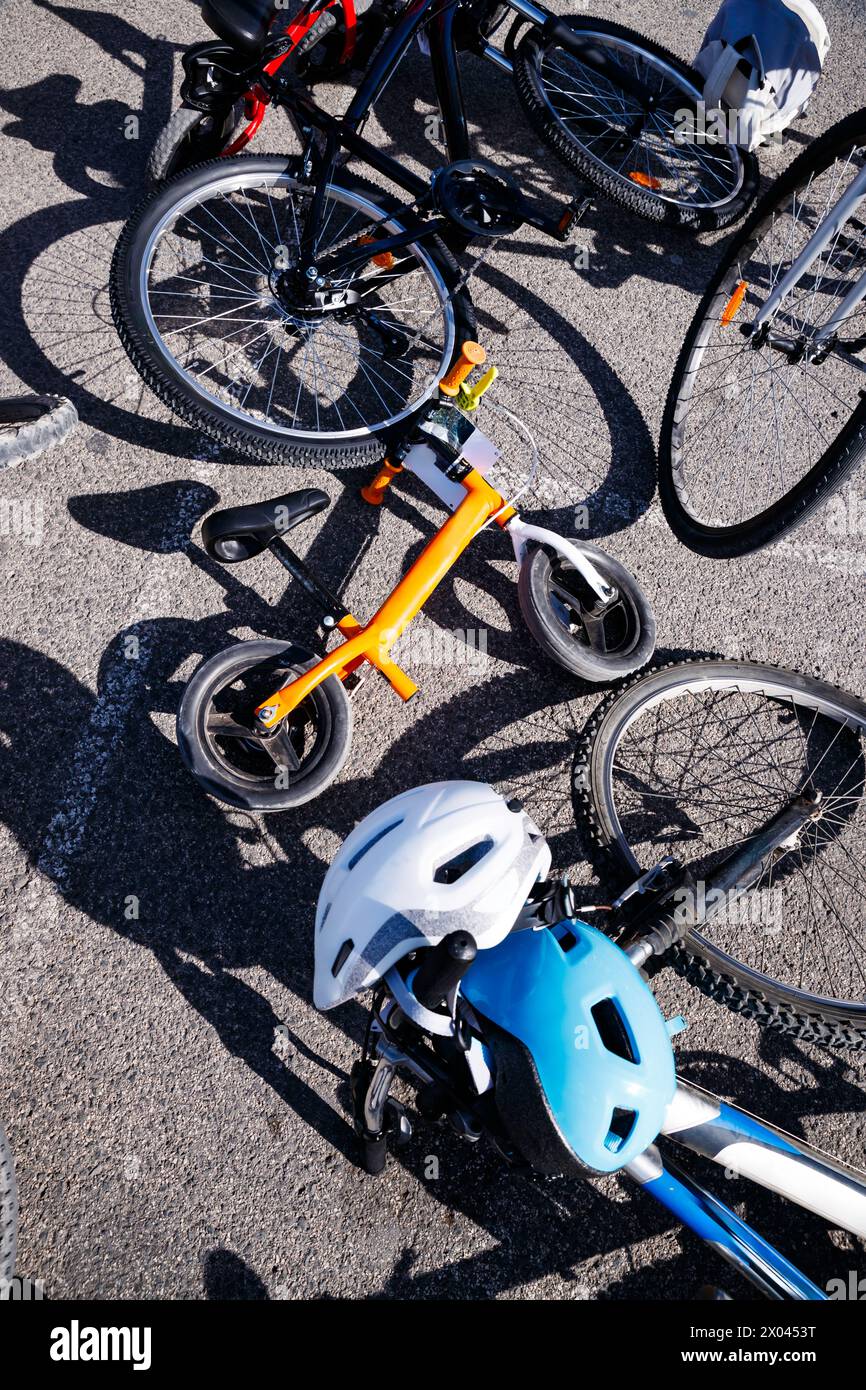Bikes with helmets on the ground in Villajoyosa Stock Photo - Alamy