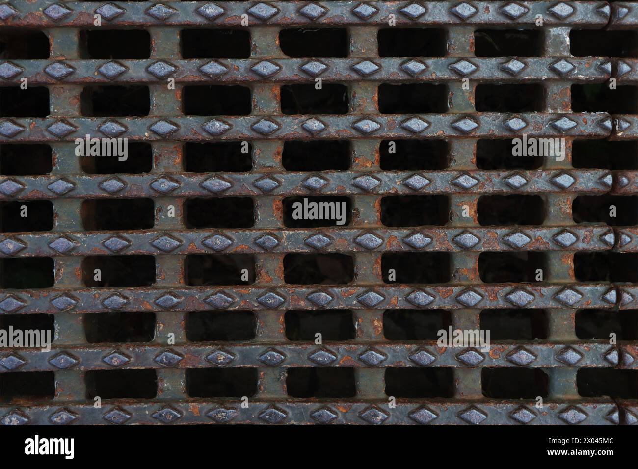 Rusty sewer drain grate. Metal grate top view Stock Photo - Alamy