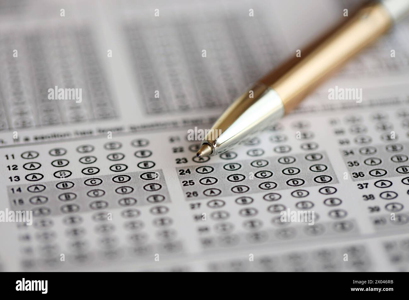 Blank educational test for students lies on table in classroom with pen ...