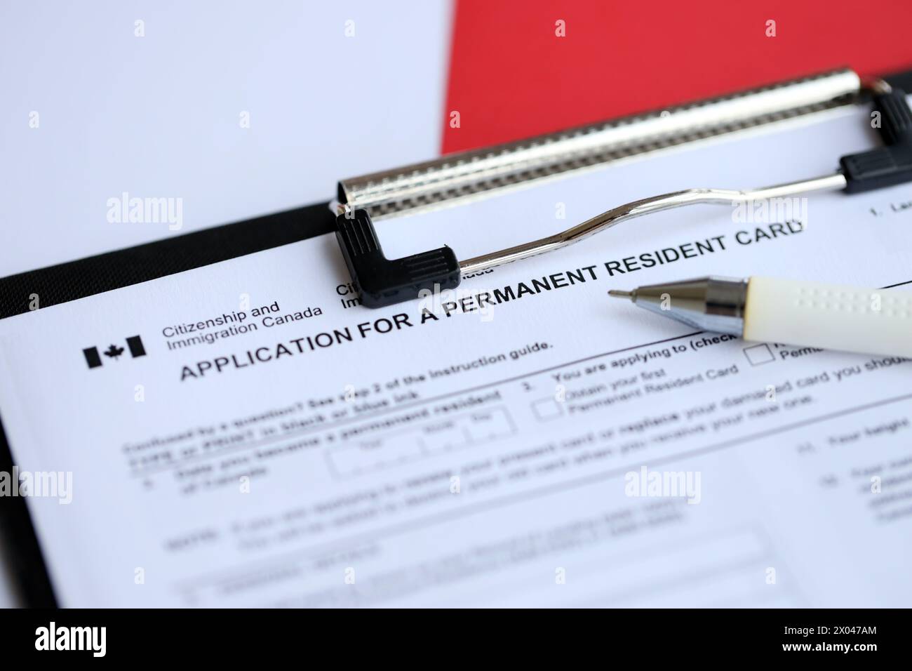 Application for permanent resident card on table with pen close up ...