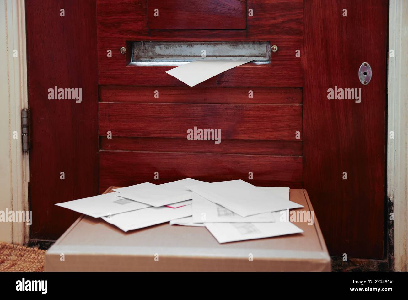 Wooden door with mail slot, many envelopes and cardboard indoors Stock ...
