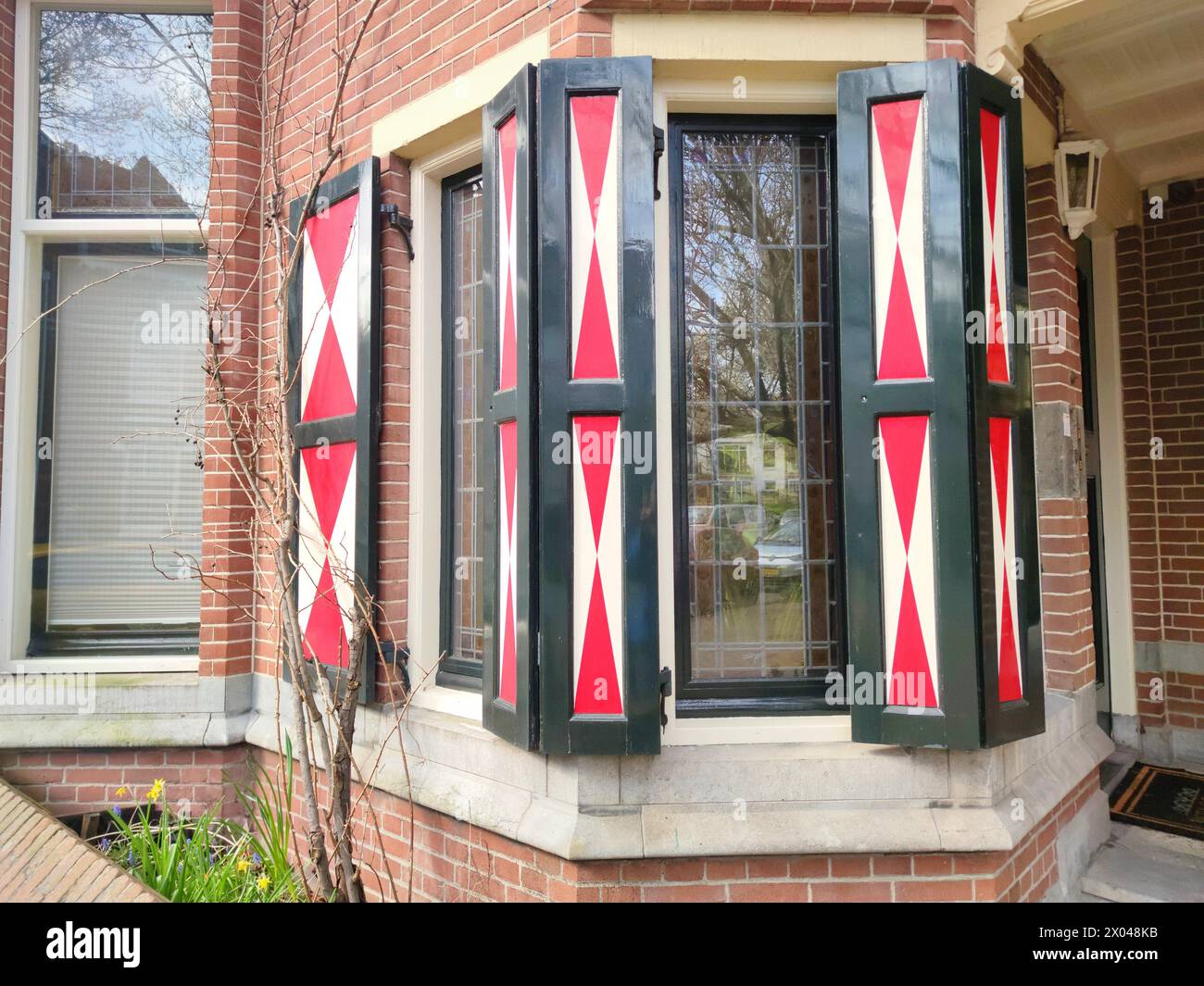 Traditional red and white shutters on the windows of a Dutch house ...