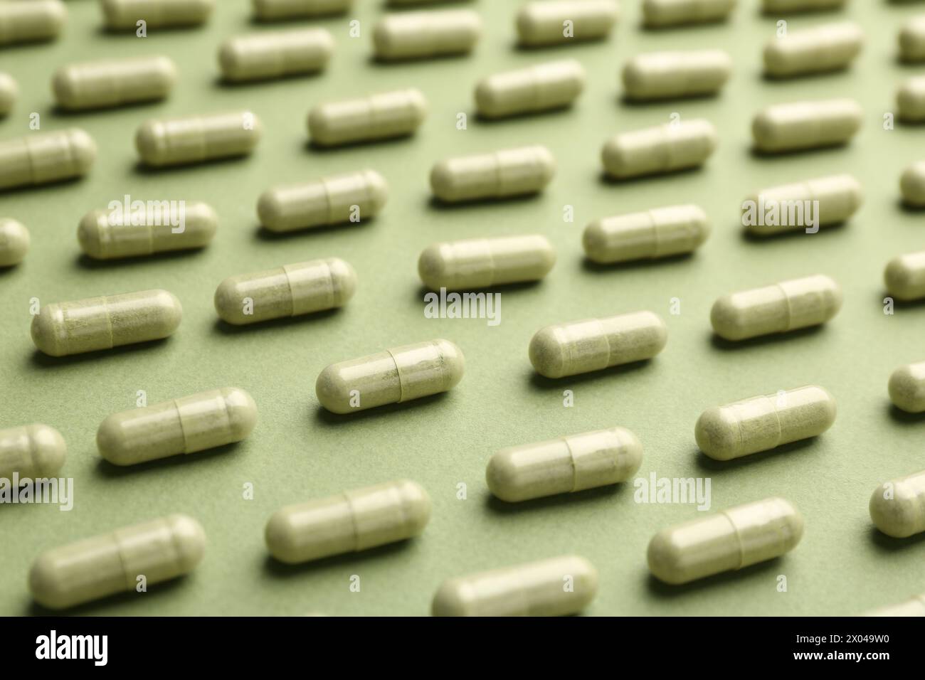 Many vitamin capsules on olive background, closeup Stock Photo - Alamy