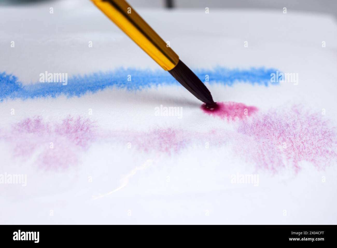 Wet on wet technique. Artist applying wet watercolor paint to wet paper ...