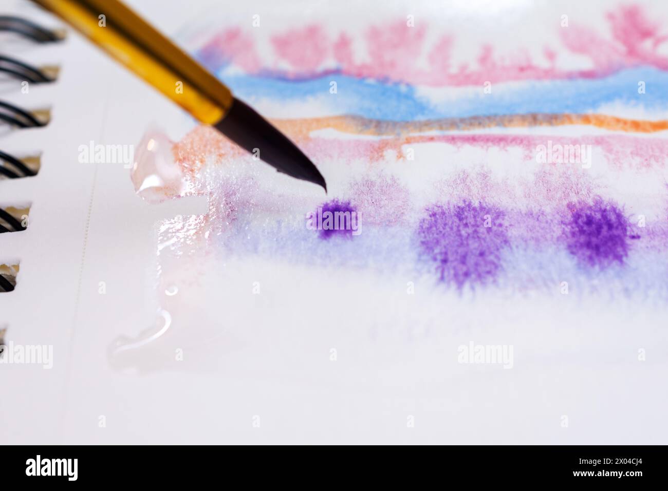 Wet on wet technique. Artist applying wet watercolor paint to wet paper ...