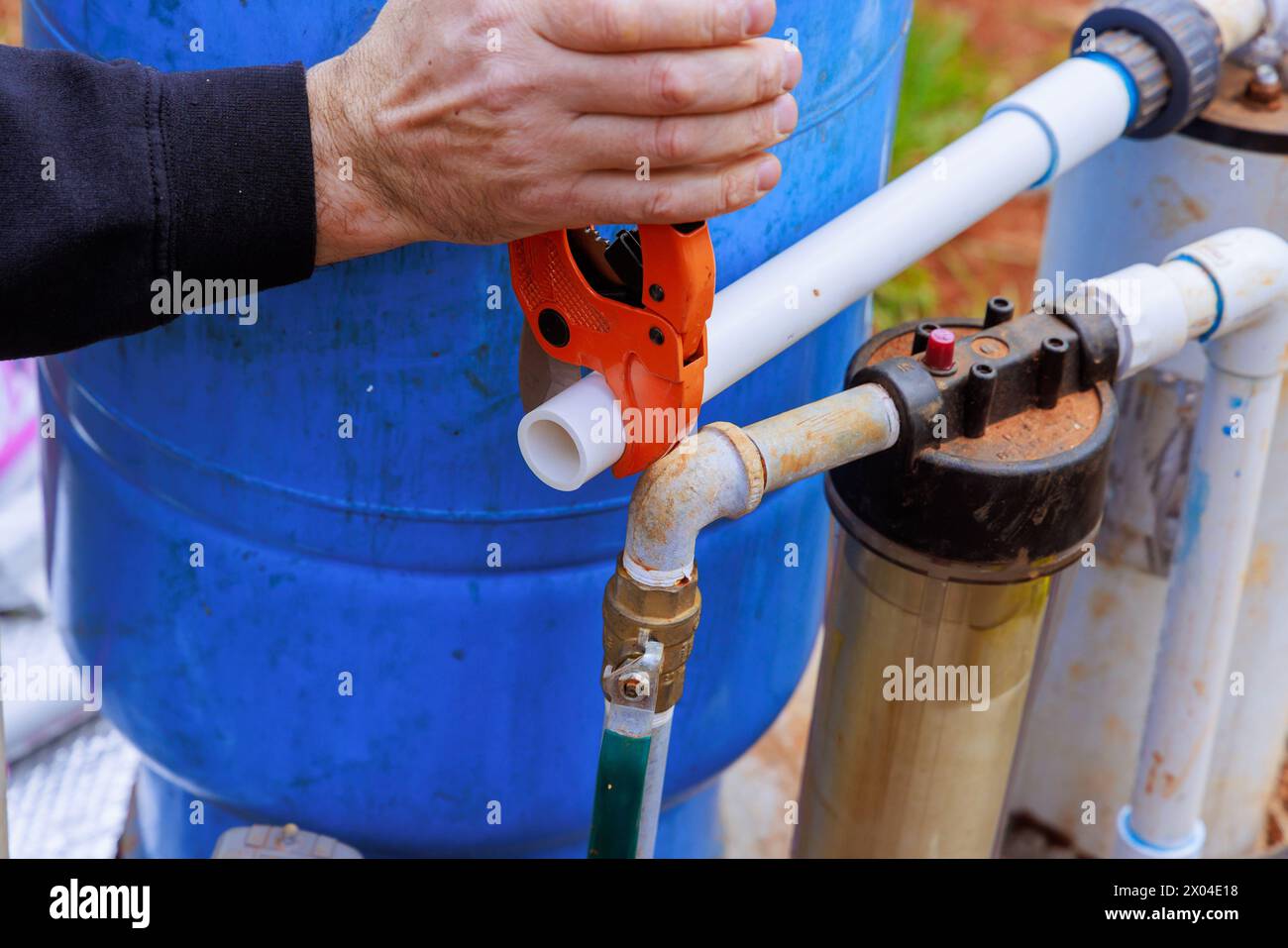 Using special pair of scissors, plumber cuts plastic PVC pipe Stock ...