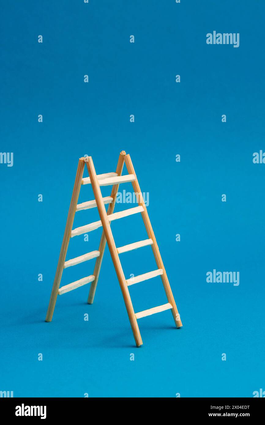 Two ladders leaning against each other Stock Photo - Alamy