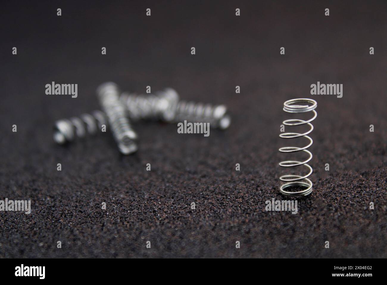 Group of springs where one is separated from the rest Stock Photo - Alamy