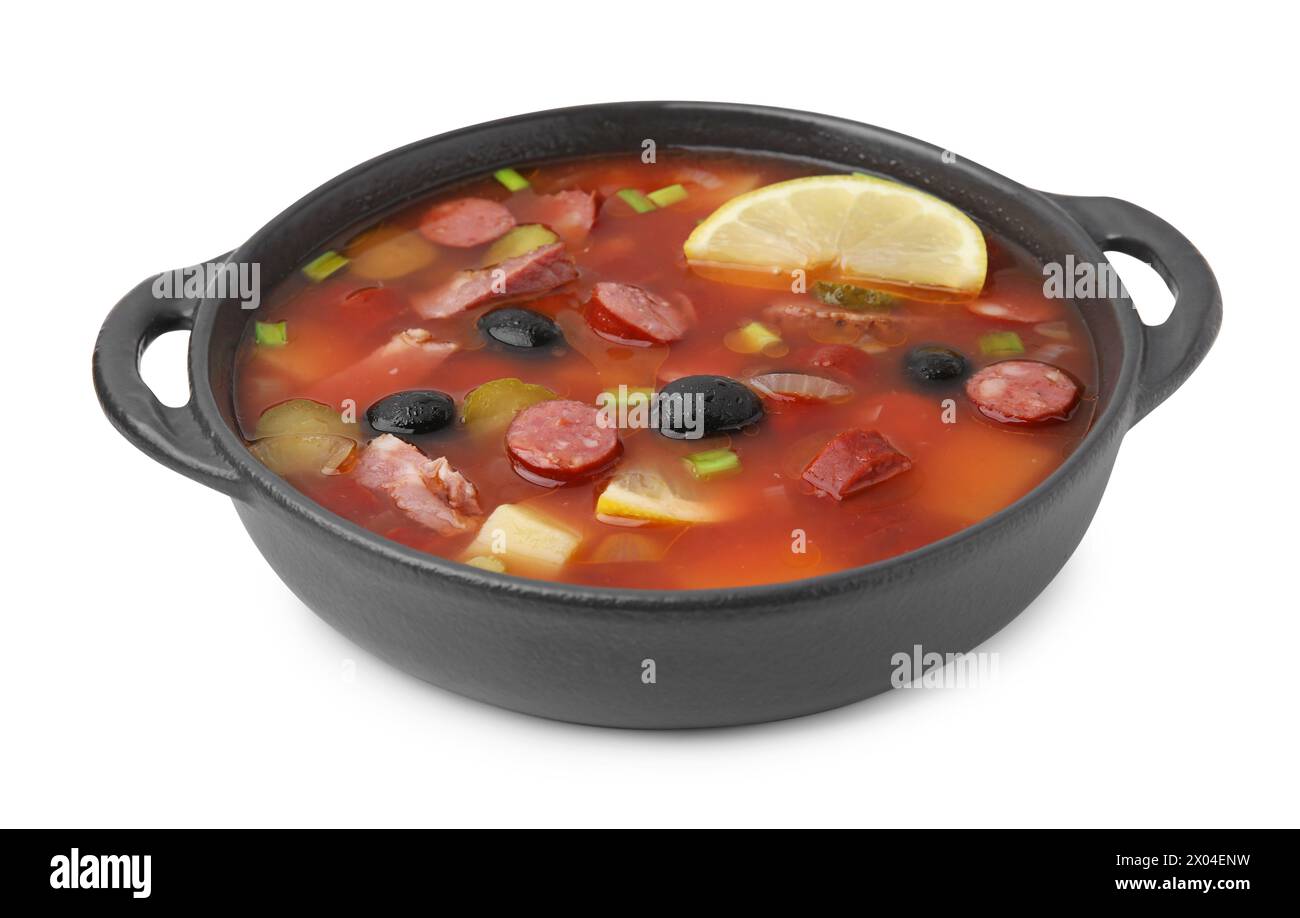 Meat solyanka soup with thin dry smoked sausages in bowl isolated on ...