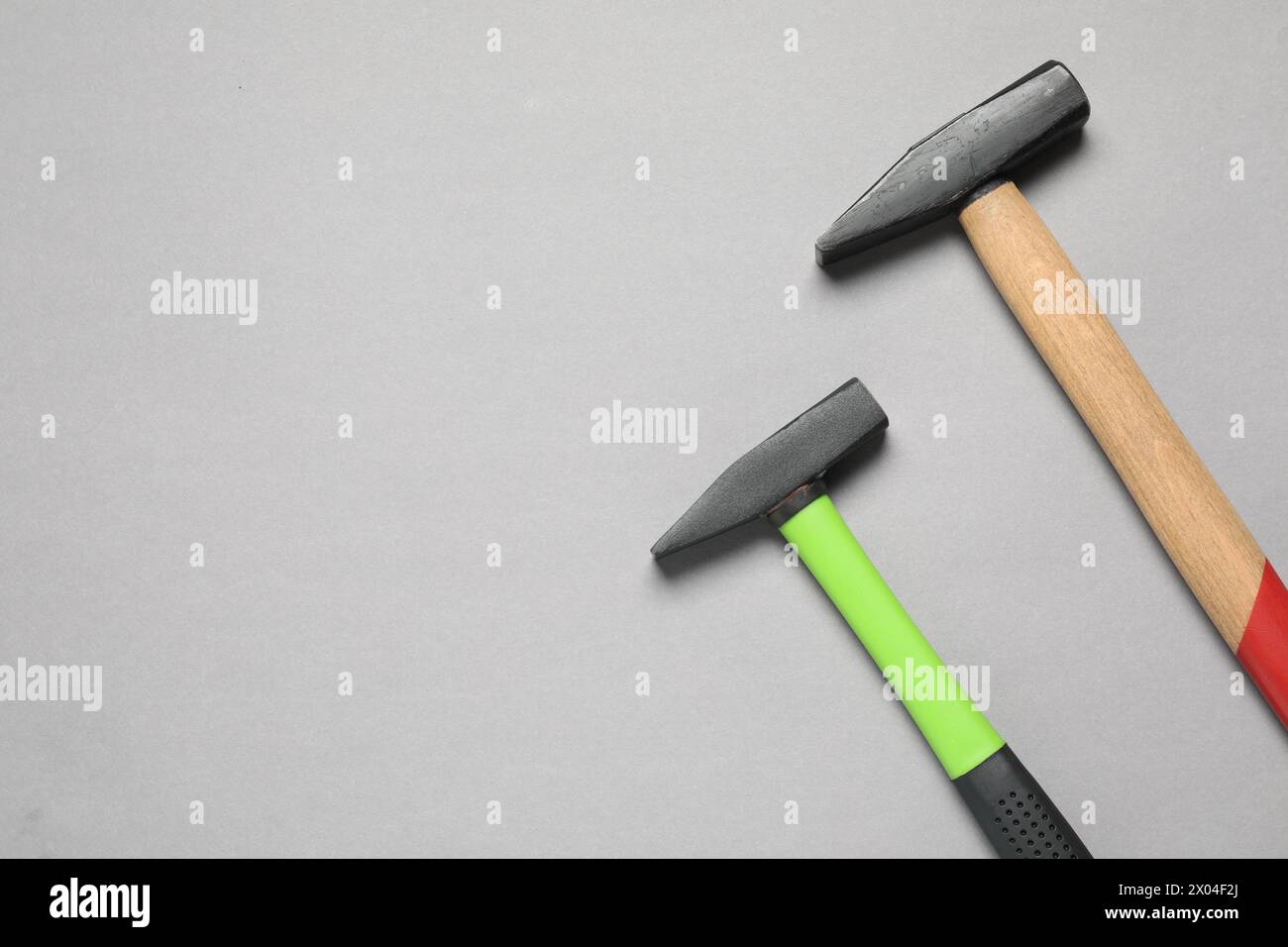 Two hammers on grey background, top view. Space for text Stock Photo ...