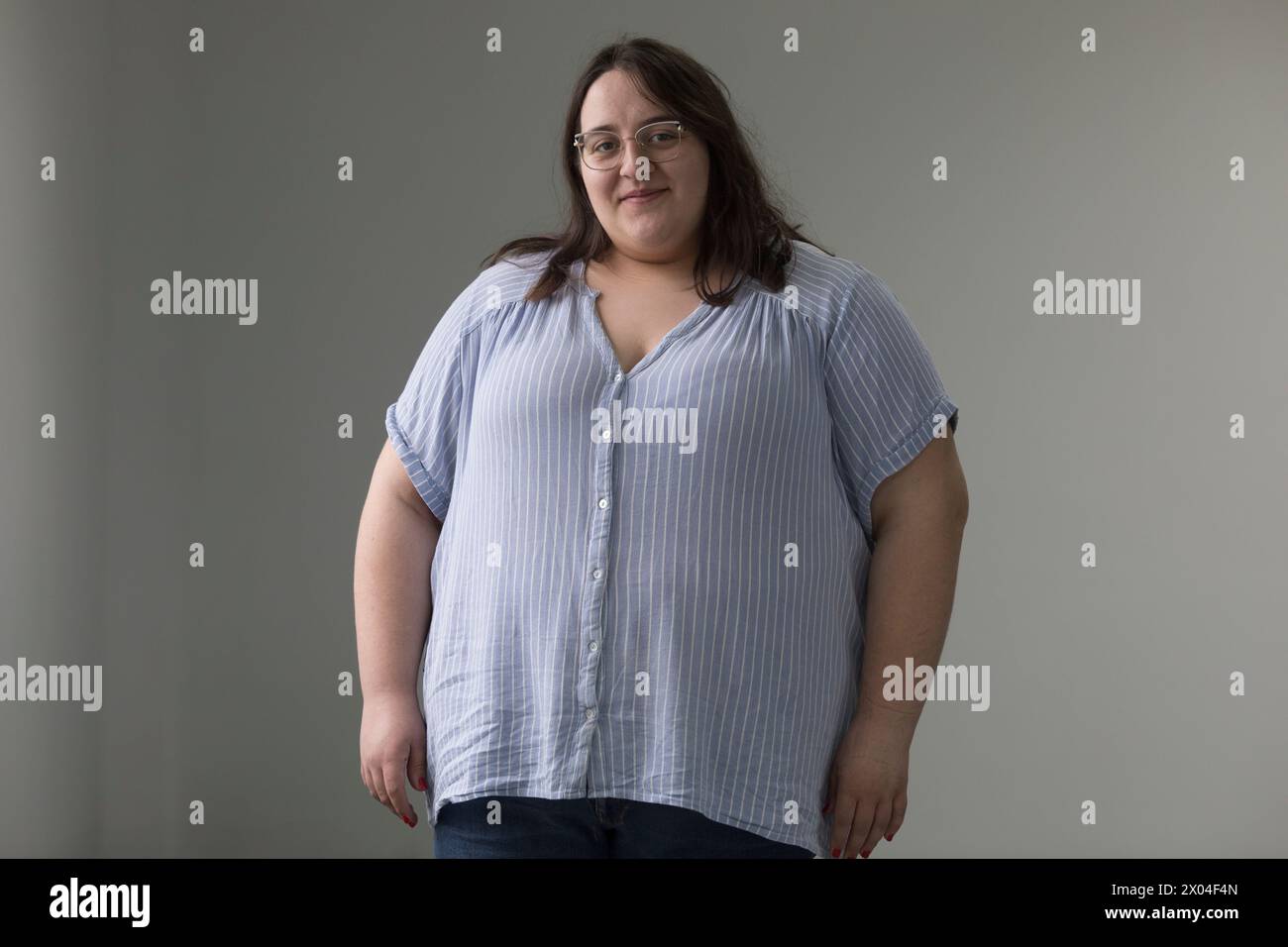 Vertical portrait with soft background of young overweight girl with ...