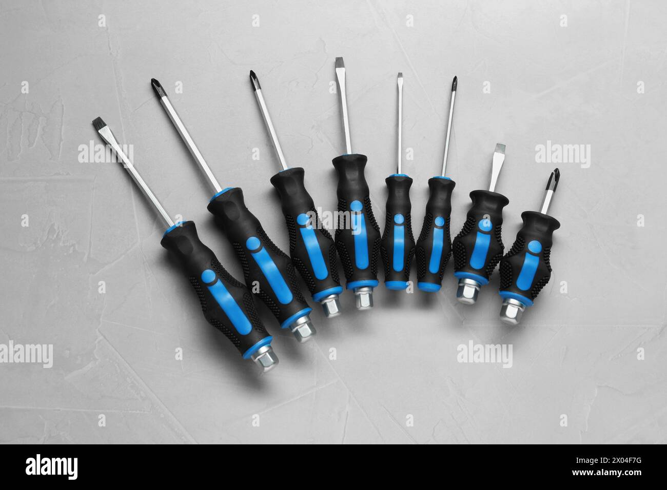 Set of screwdrivers on light grey background, flat lay Stock Photo - Alamy