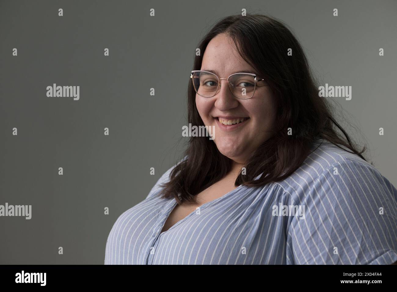 Vertical portrait with soft background of young overweight girl with ...