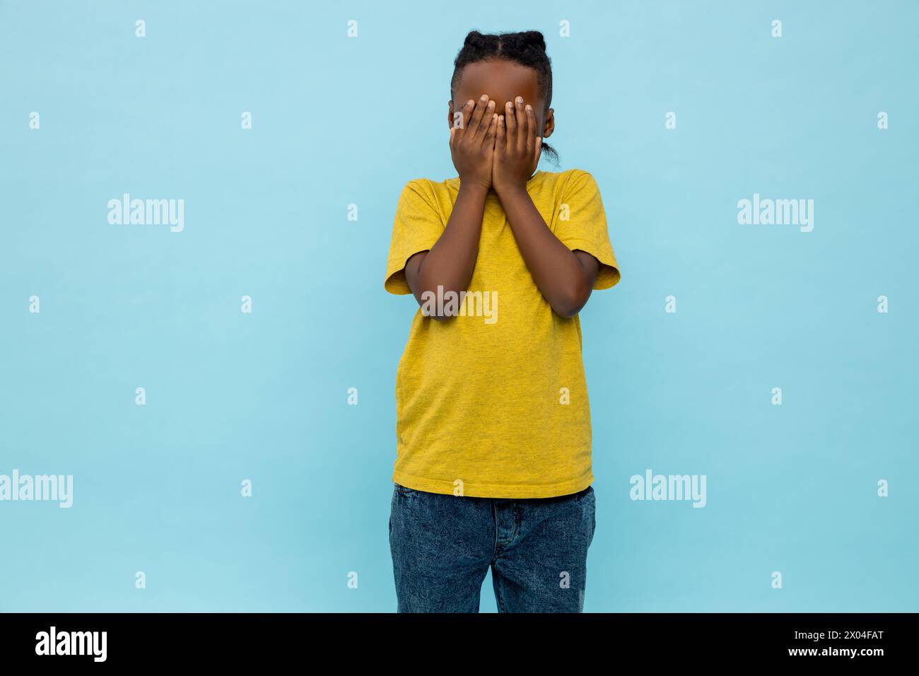 Scared dark- skinned little boy covering his eyes Stock Photo - Alamy
