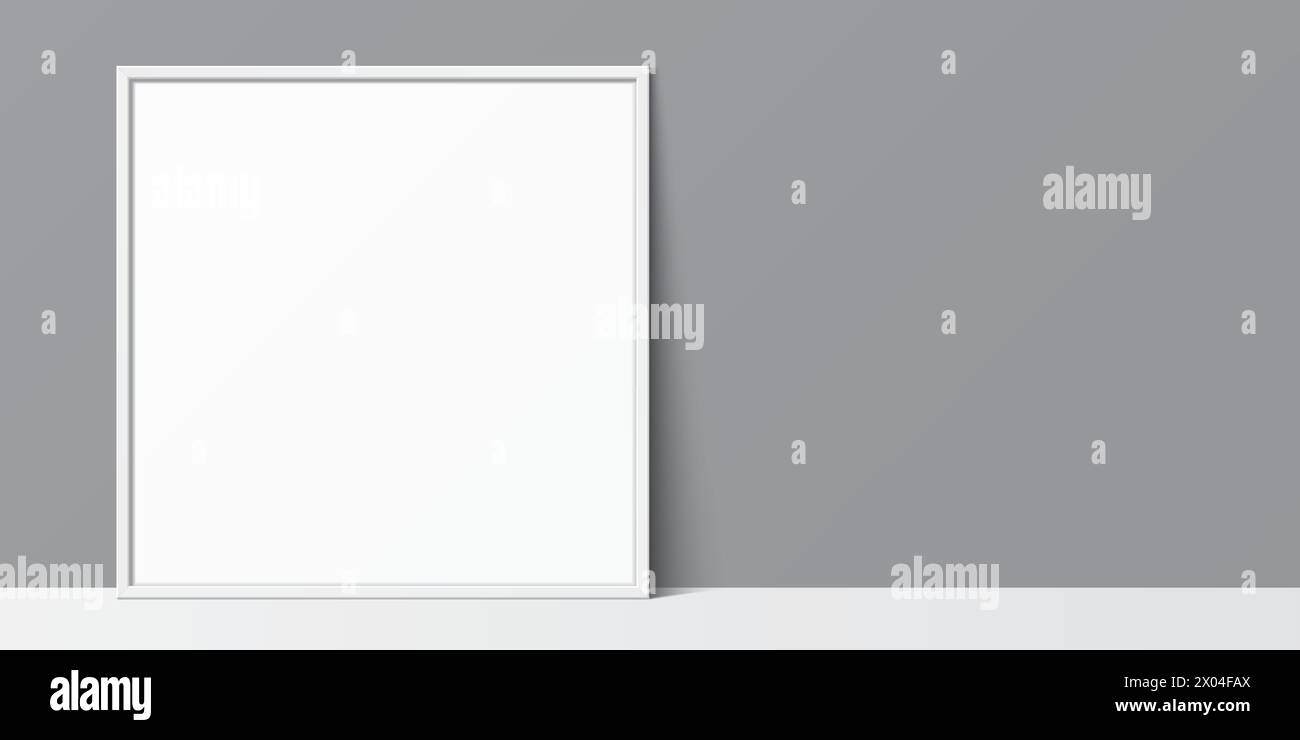 Square shape white poster frame leaning against a grey wall background ...