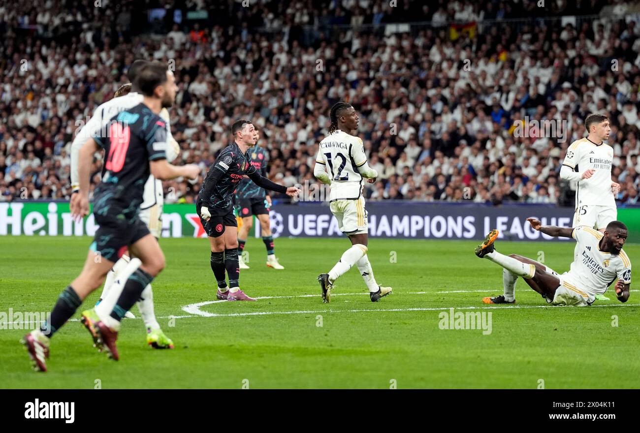Manchester City's Phil Foden watches his shot beat Real Madrid's Andriy ...