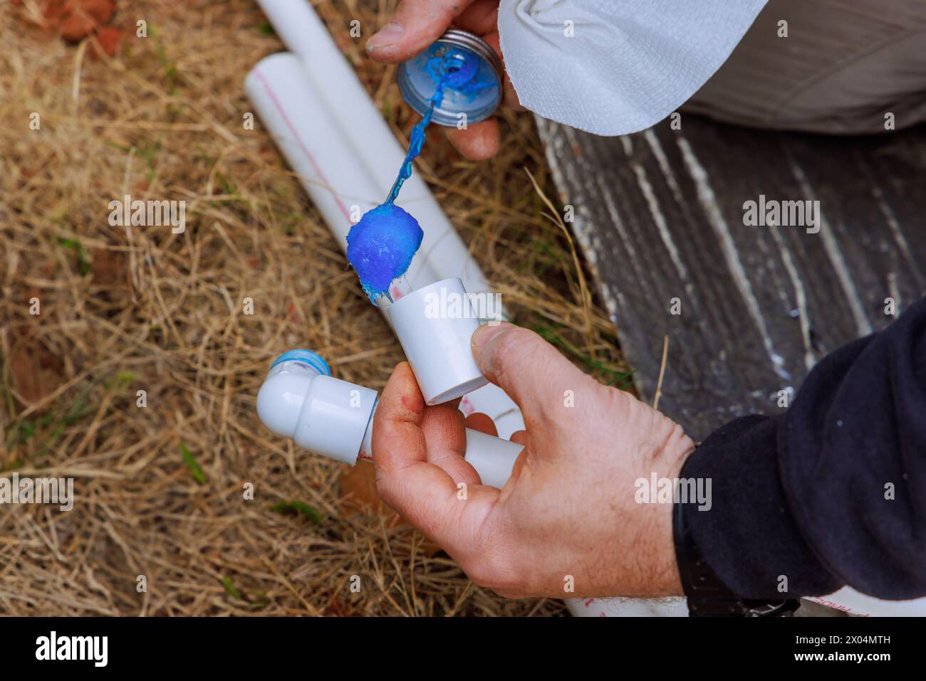Before gluing a pex pipe, plumber seals it with glue Stock Photo - Alamy