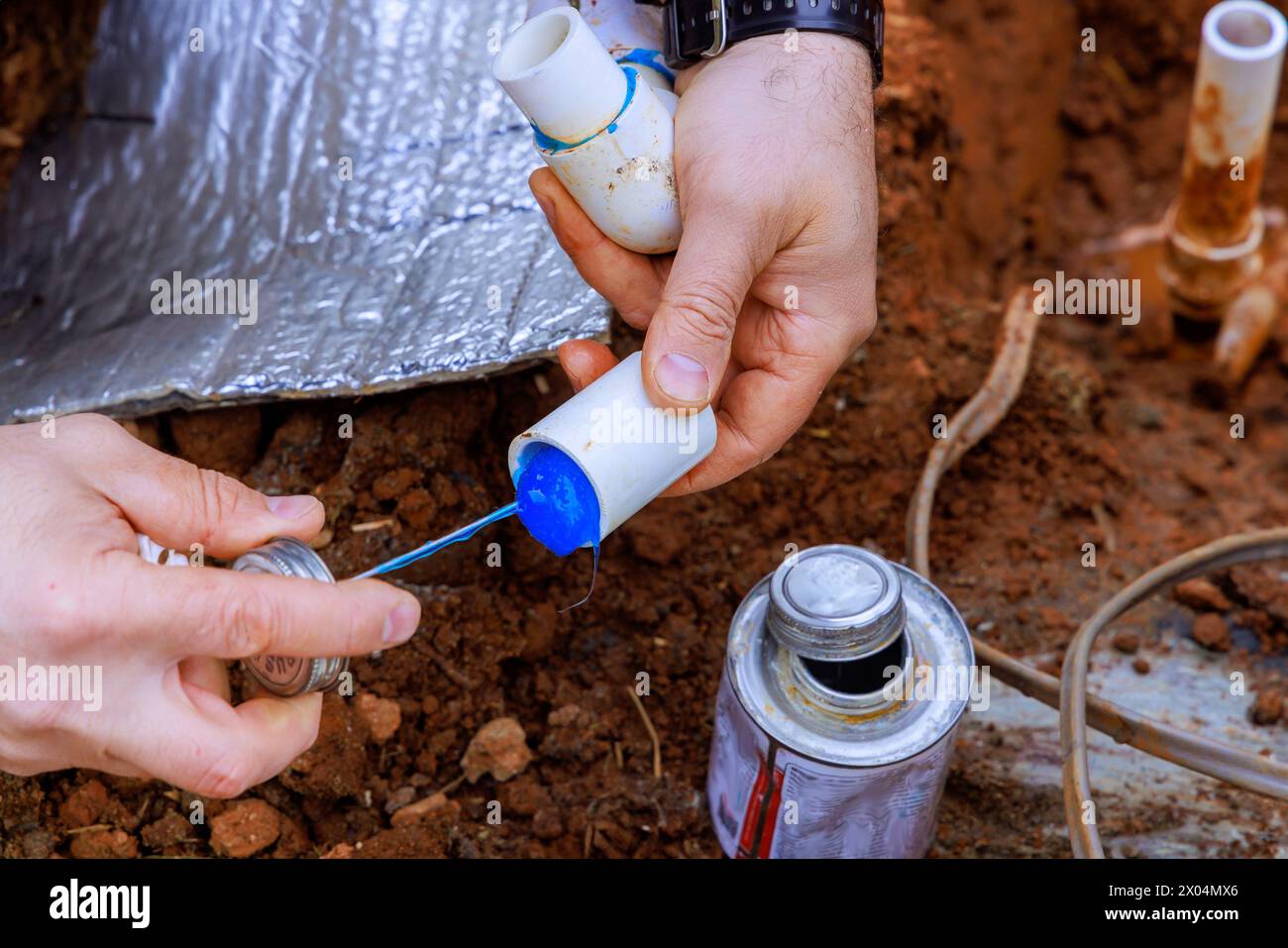 Before gluing plastic pipe with glue, plumber seals that pipe with glue ...