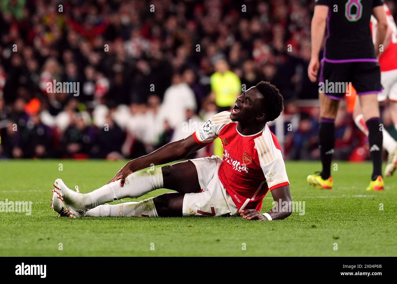 Arsenal's Bukayo Saka reacts after a challenge from Bayern Munich ...