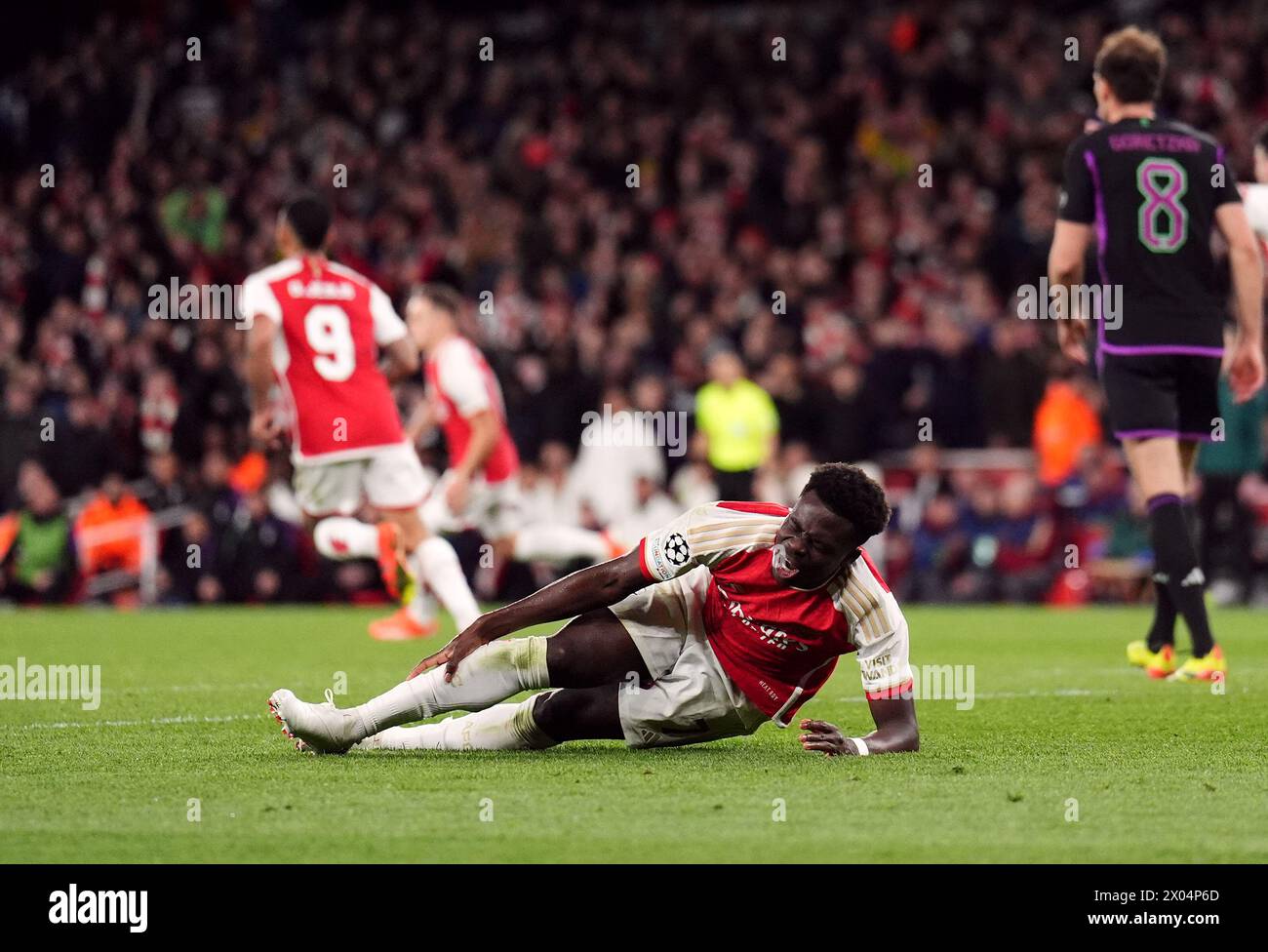 Arsenal's Bukayo Saka reacts after a challenge from Bayern Munich ...